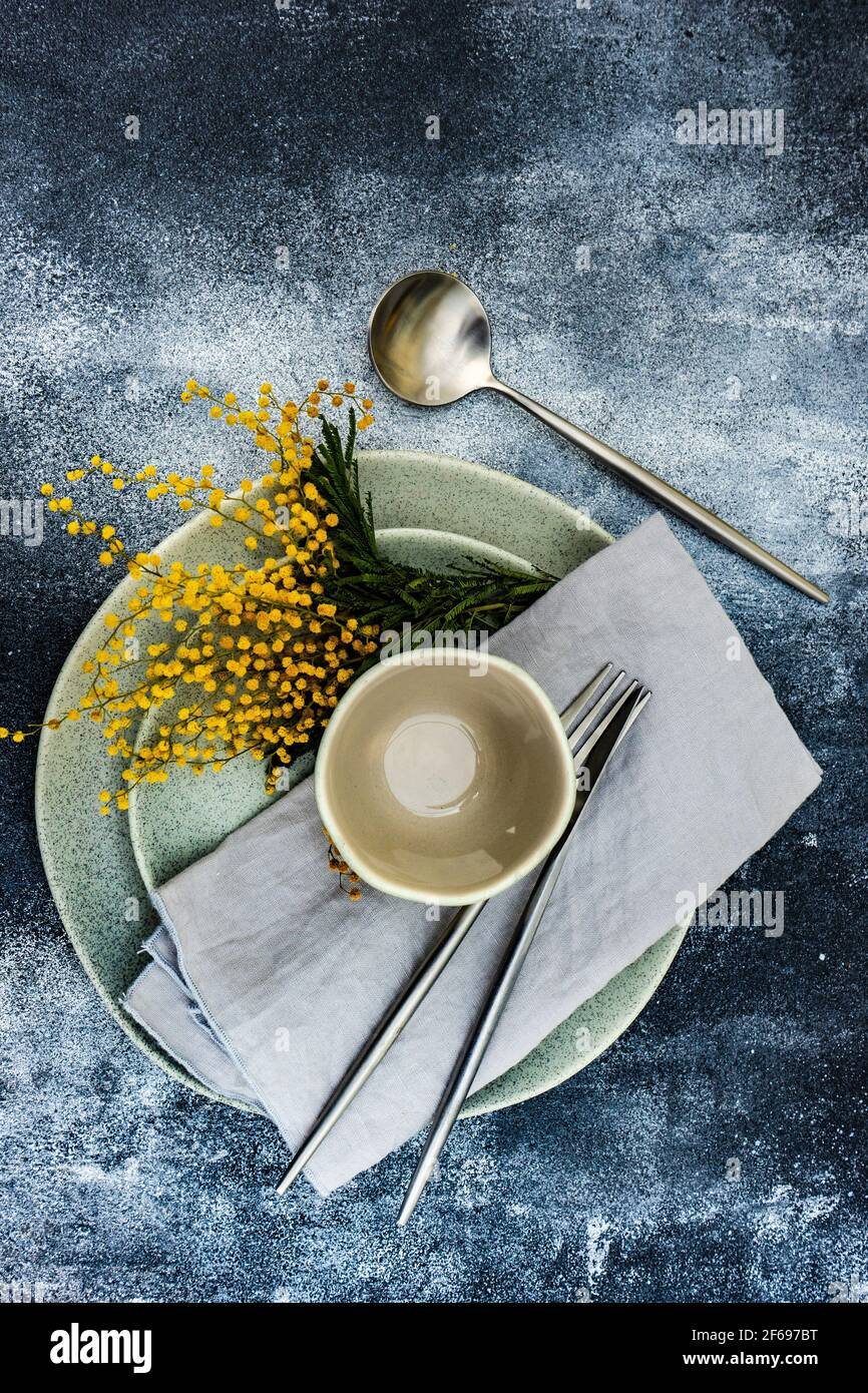 Spring mimosa flowers and table setting Stock Photo - Alamy