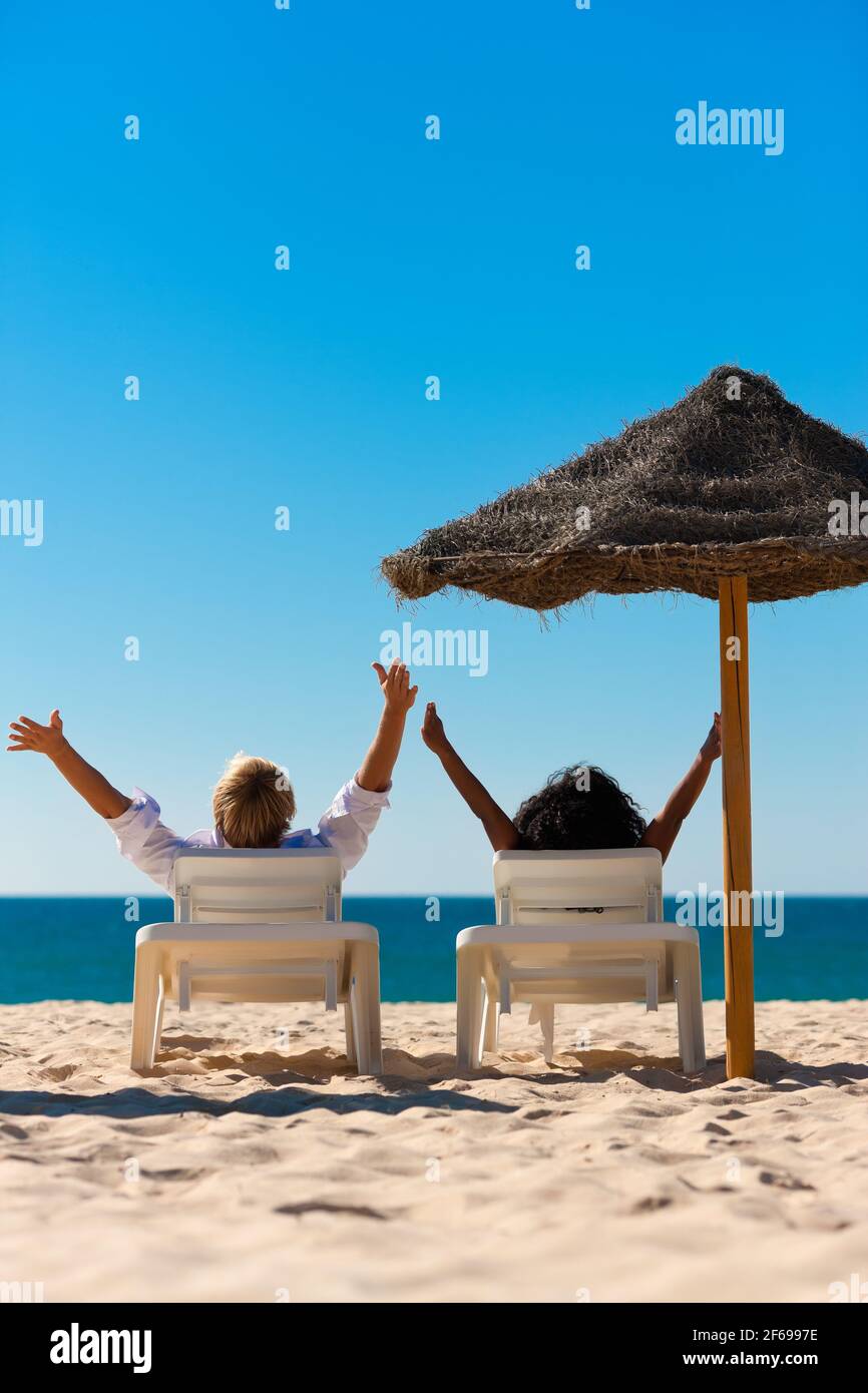 Woman under parasol on beach hi-res stock photography and images - Alamy