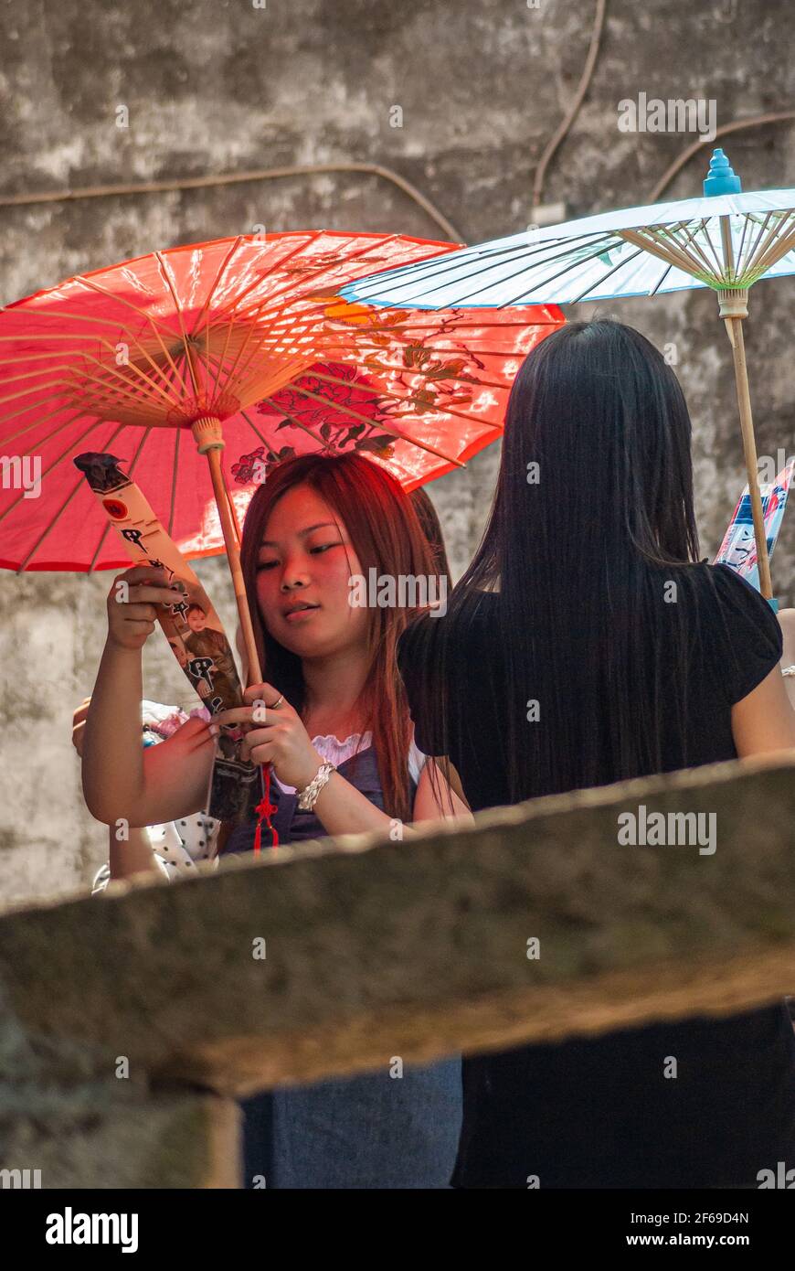 Tongli, China - May 2, 2010: Closeup of 2 young women each with sun ...