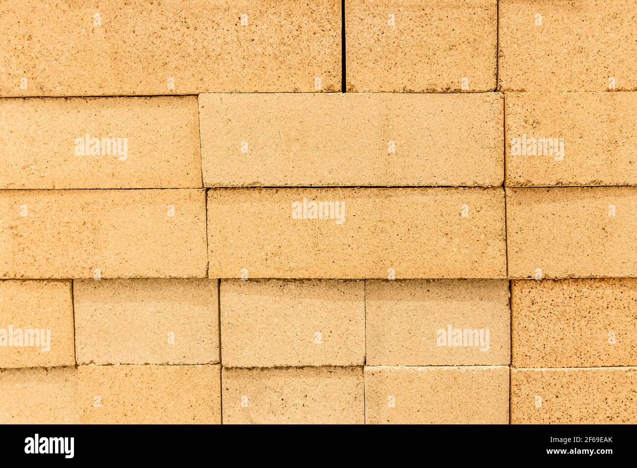 Texture of refractory sand-colored brick blocks wall closeup ...