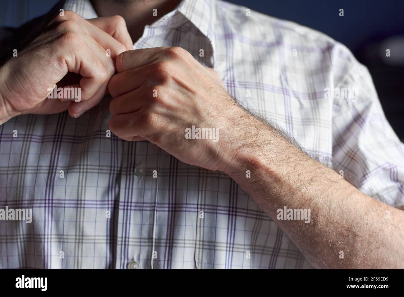 Buttoning his shirt hi-res stock photography and images - Alamy