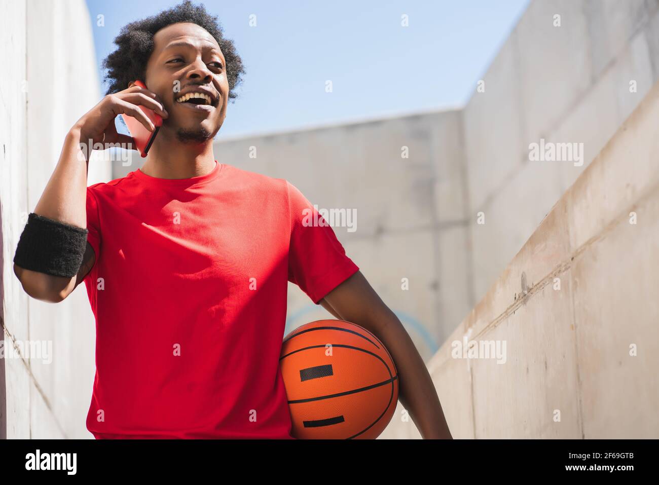 Athlete man talking on the phone Stock Photo - Alamy