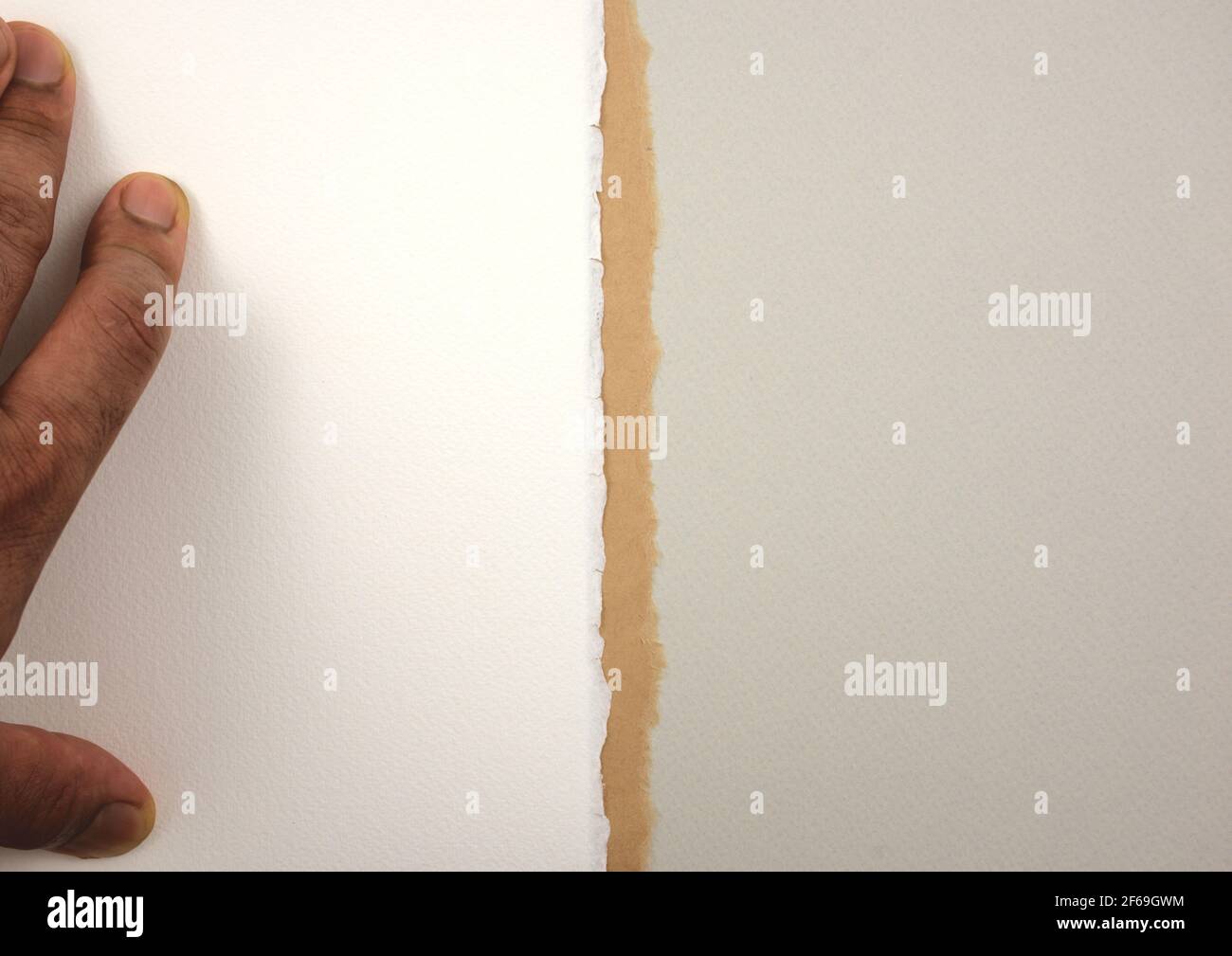 Left man tan hand putting, push down on papers. White, neutral brown ...