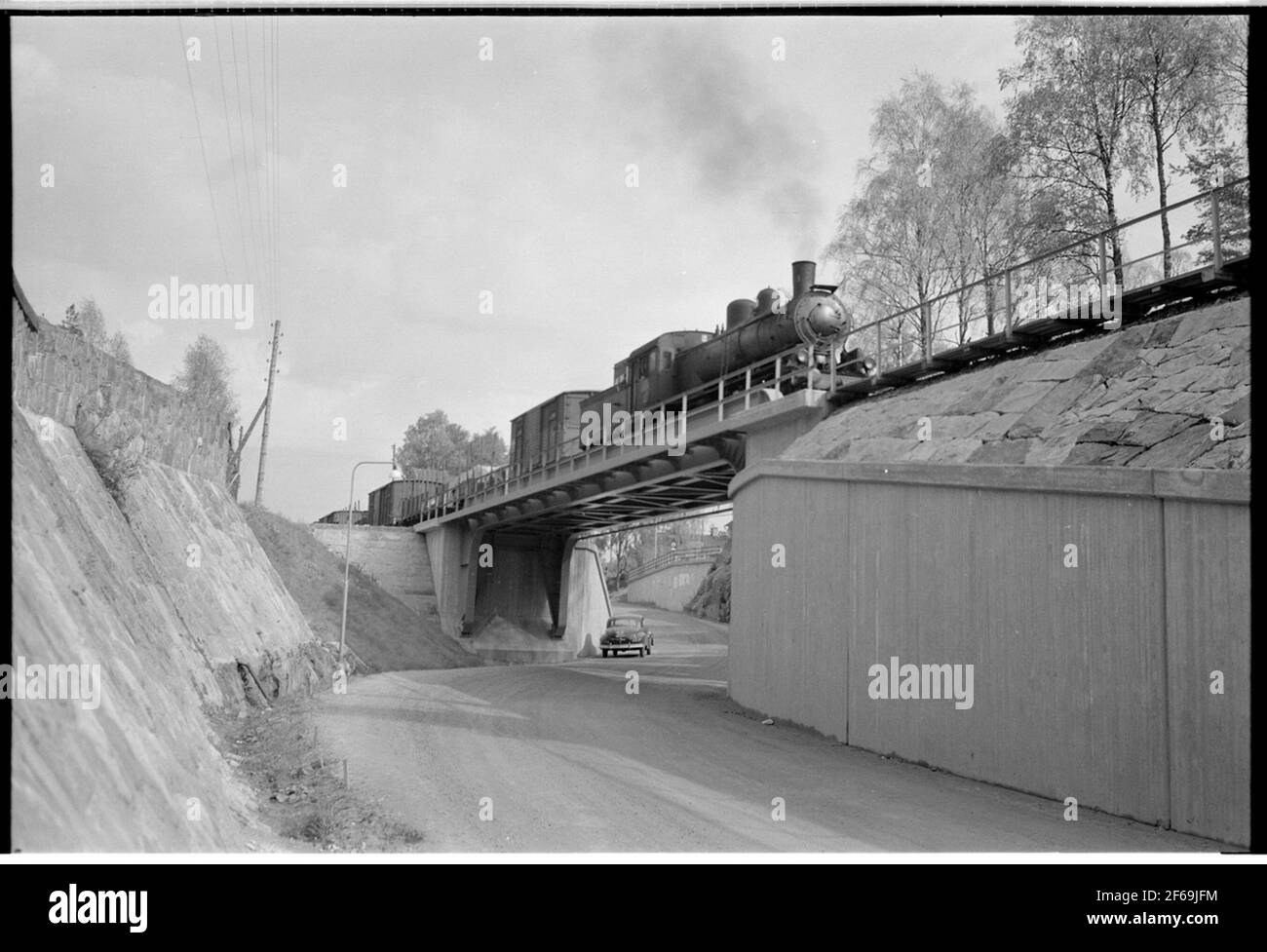 Freight train passing on a viaduct Stock Photo - Alamy