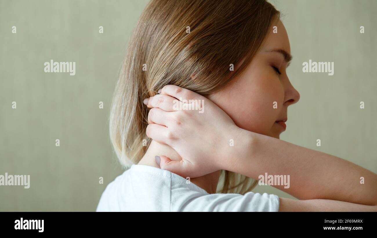 Woman holds neck with pain cervical muscle spasm by hand. Neck pain ...