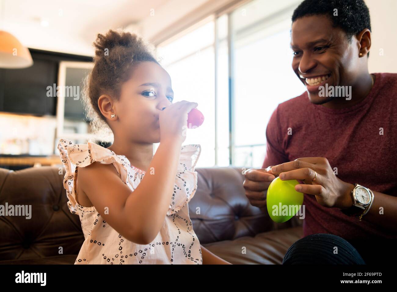 Daughter and father playing together at home Stock Photo - Alamy