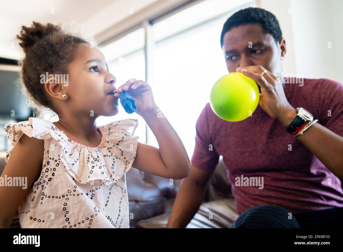 Daughter and father playing together at home Stock Photo - Alamy