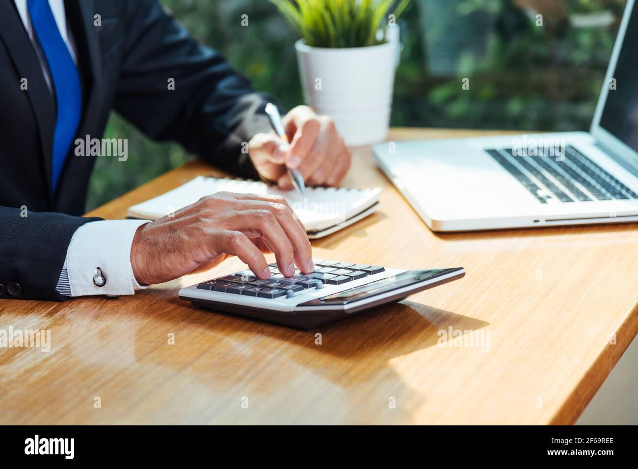 Business man accounting using calculating and work with laptop computer ...