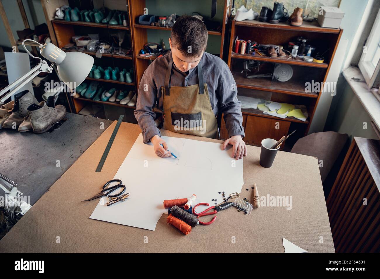Manual production of shoes in the workshop the shoemaker begins with ...