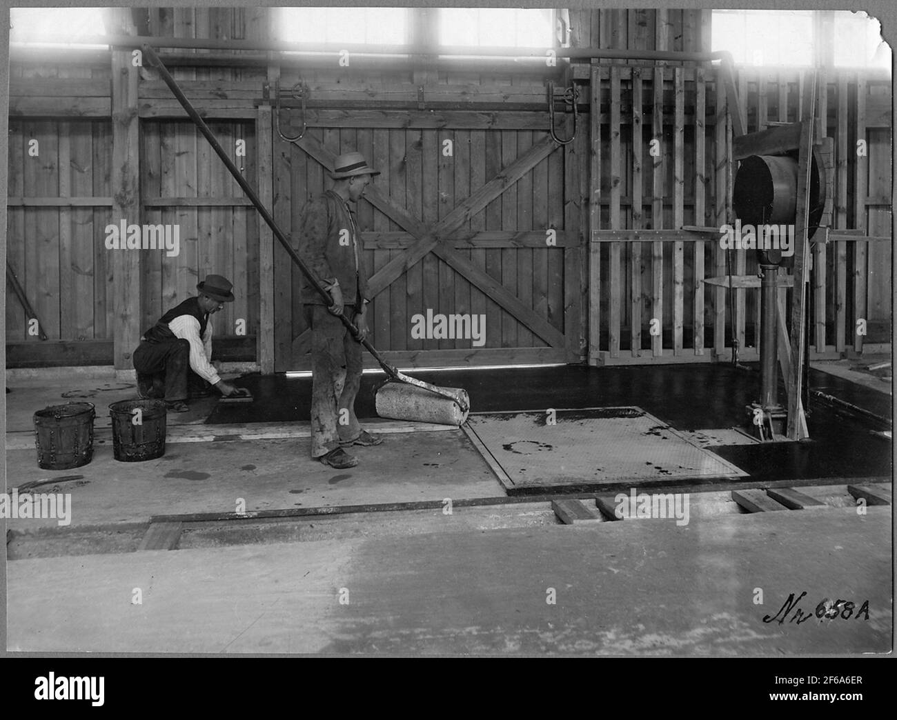 Laying asphalt floor in goods and translation magazine Stock Photo - Alamy