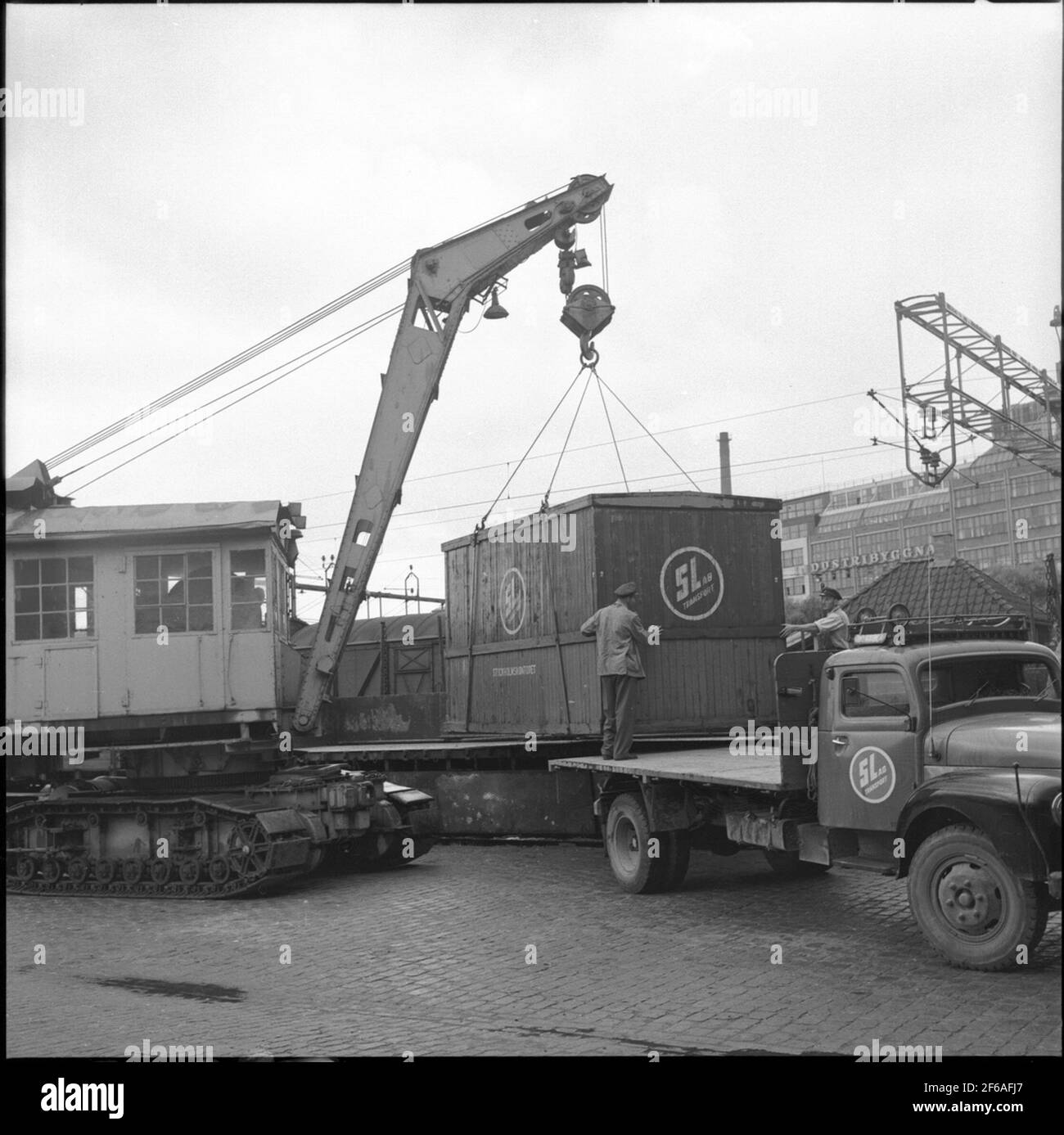 Old lifting crane lifts slab moving box, so-called lift Stock Photo - Alamy
