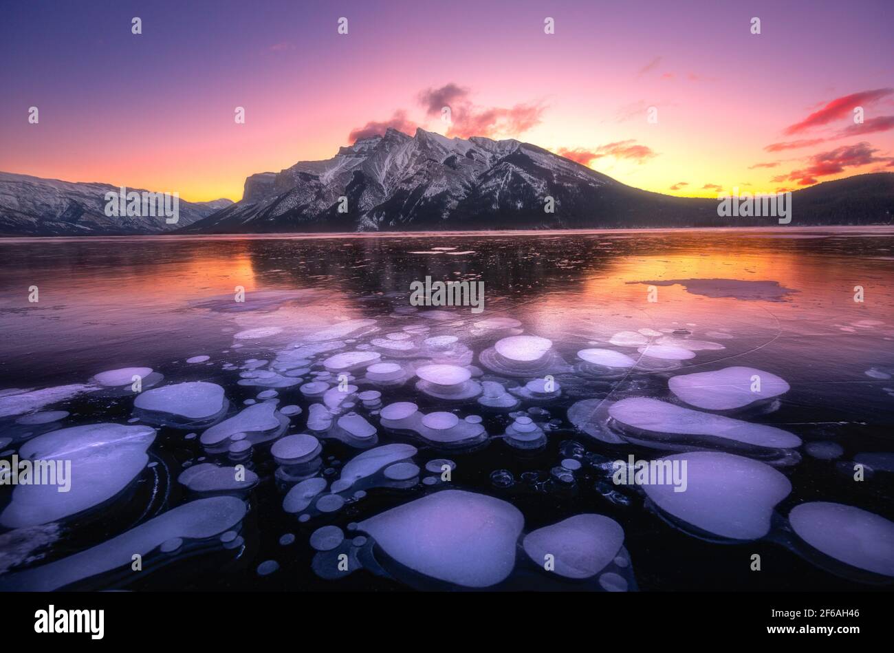 Ice bubbles on the surface of the blue ice. Frozen lake in winter ...
