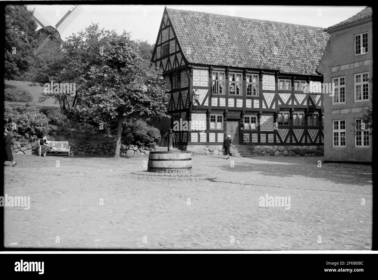 Fountain at cobbled square at the old village, open air museum in ...