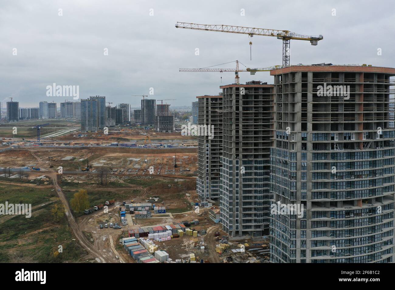 Construction cranes standing near multi storey buildings Stock Photo ...