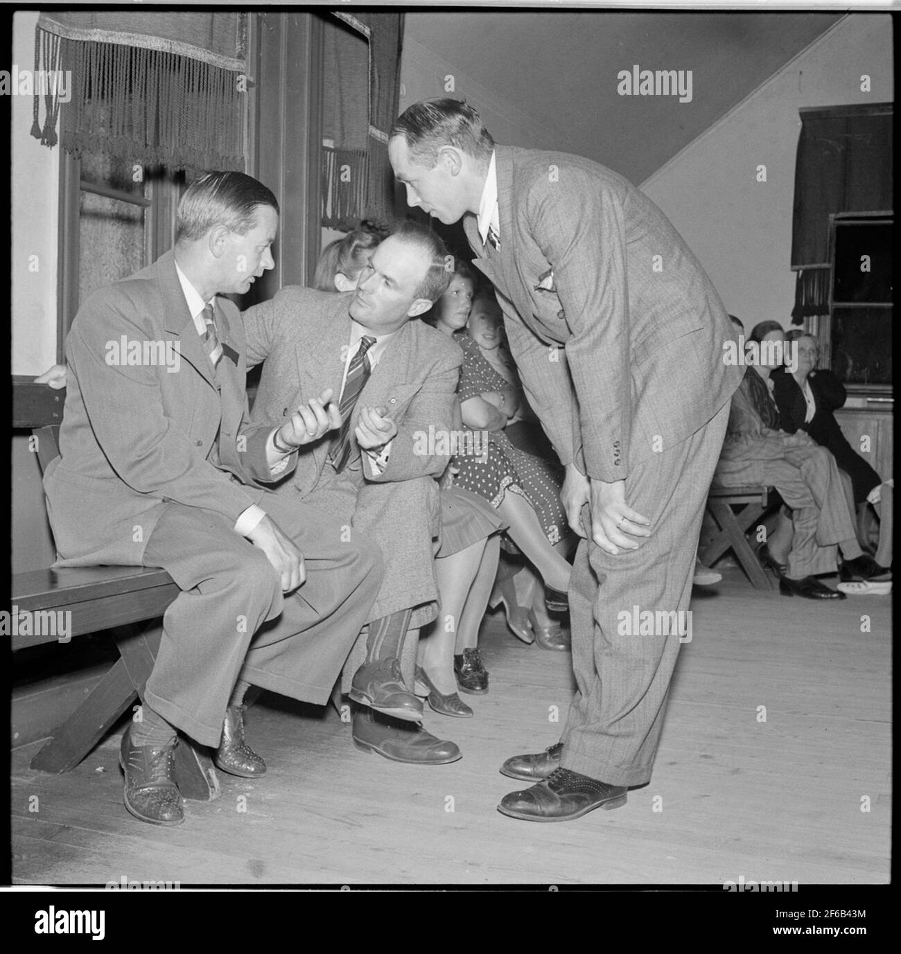 Men and women in a local. 3 men talking Stock Photo - Alamy