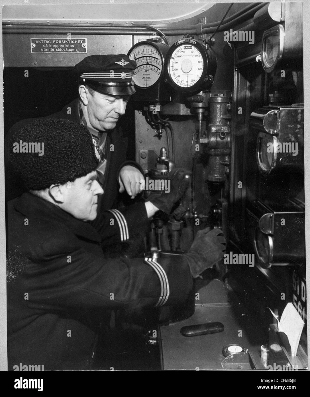 The train driver and station inspector in the cab to SJ DK Stock Photo ...