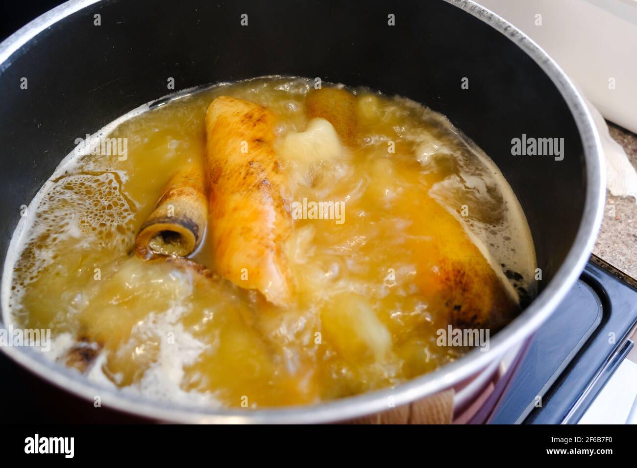 Nigerian cow skin or ponmo boiling in a pot Stock Photo - Alamy