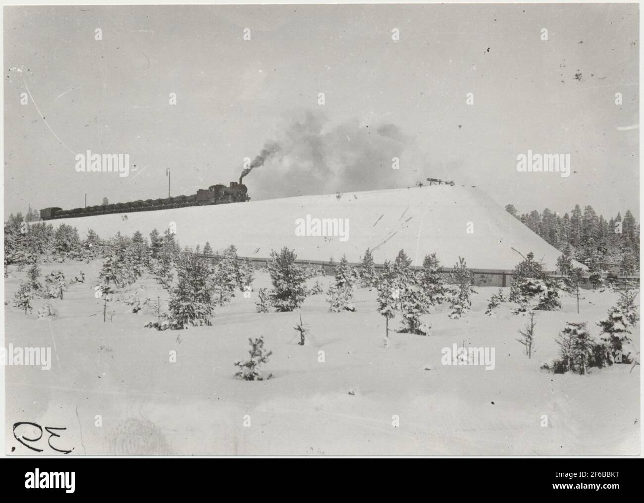 Steam locomotive with ore carts on the tail track on black island Stock ...