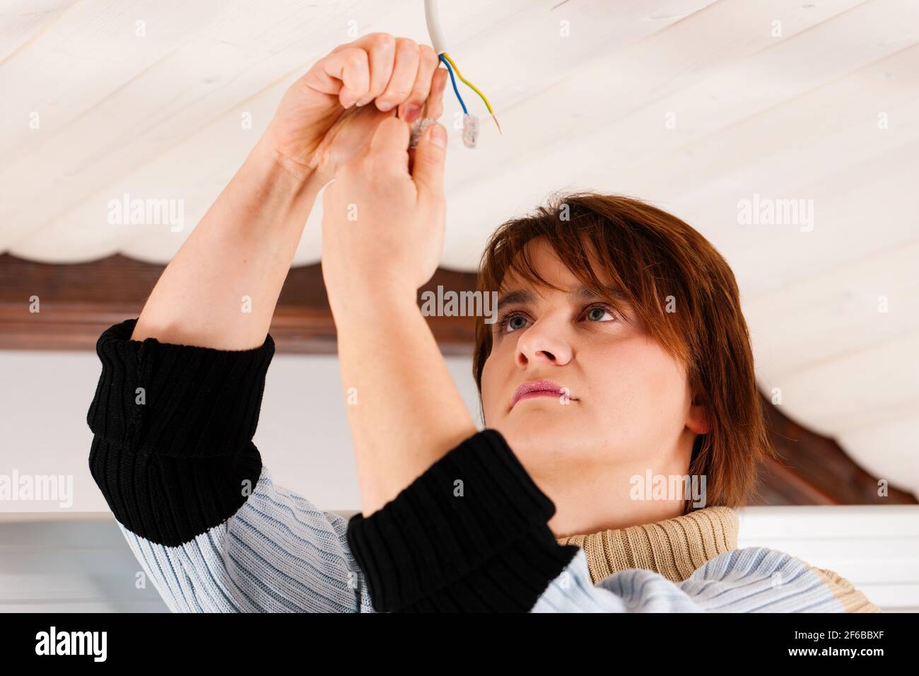 Female worker doing work on electrical installation Stock Photo - Alamy
