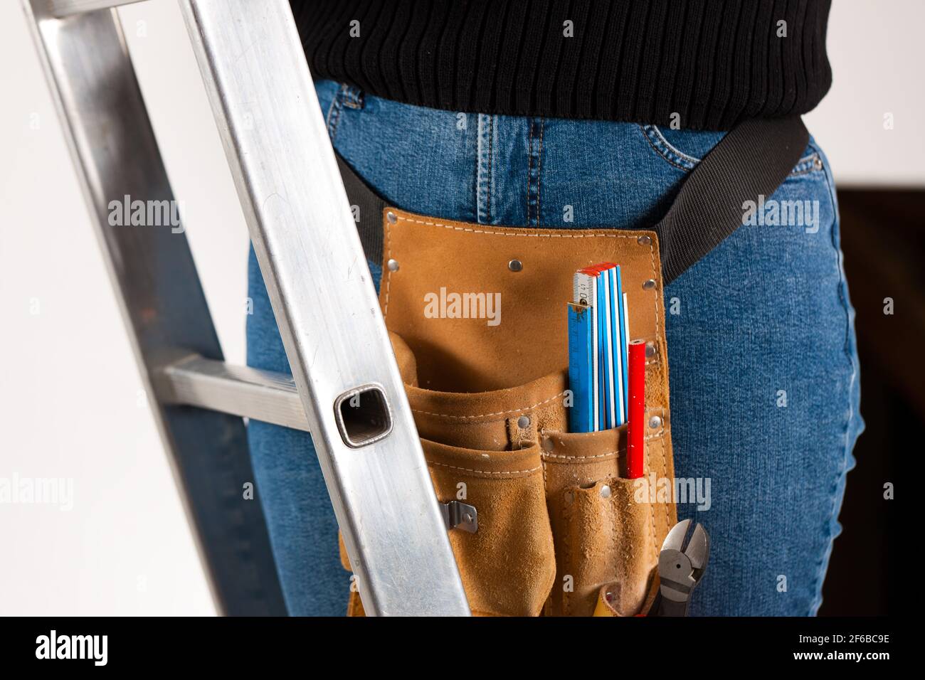 Female worker on a ladder with tools in holster Stock Photo - Alamy