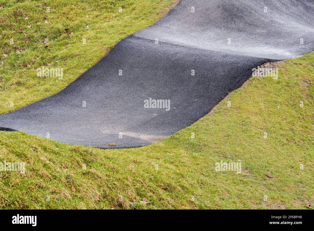 Bicycle pump track grass and asphalt abstract background, sports theme ...
