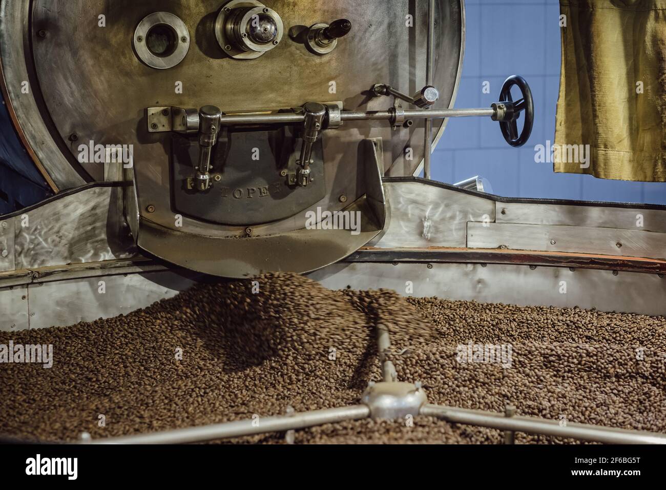 Coffee being mixed in a coffee roasting machine. Mixing coffee Stock ...