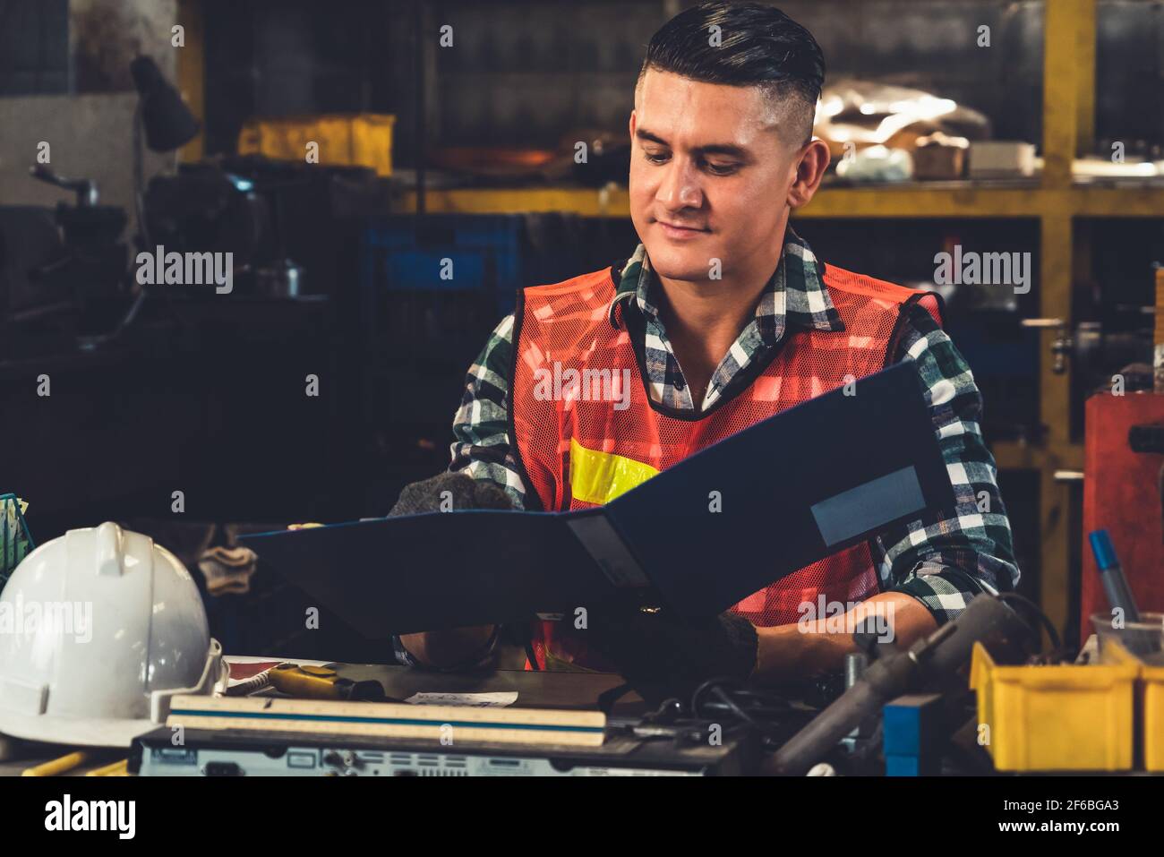 Manufacturing worker working with clipboard to do job procedure ...