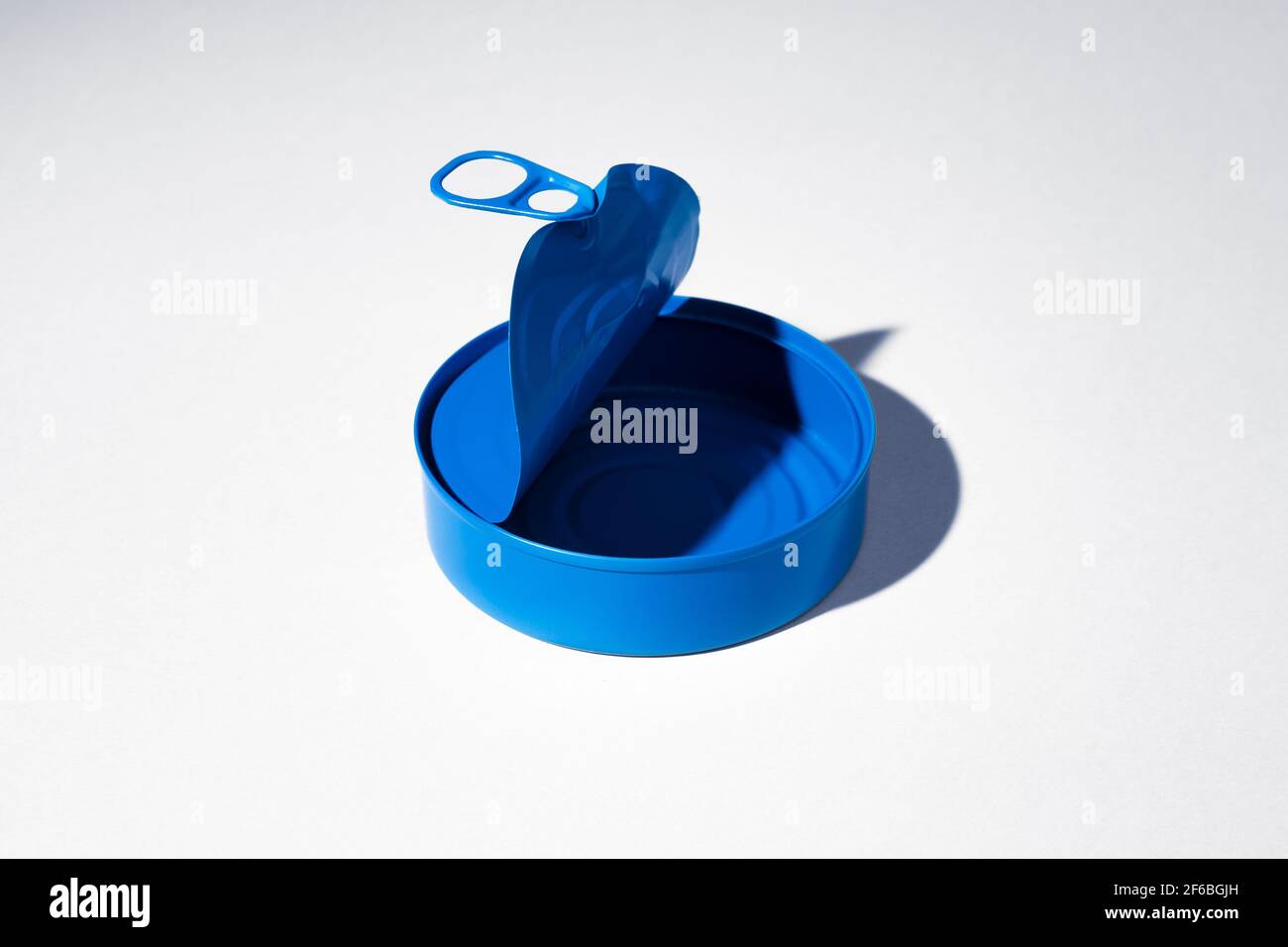 Painted blue opened tin can with ring on white background Stock Photo ...