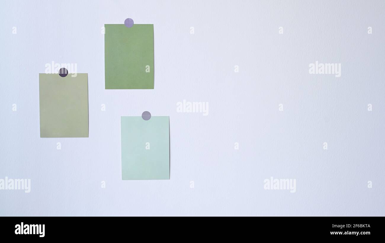 Empty sticky note attached to a white wall in meeting room Stock Photo ...