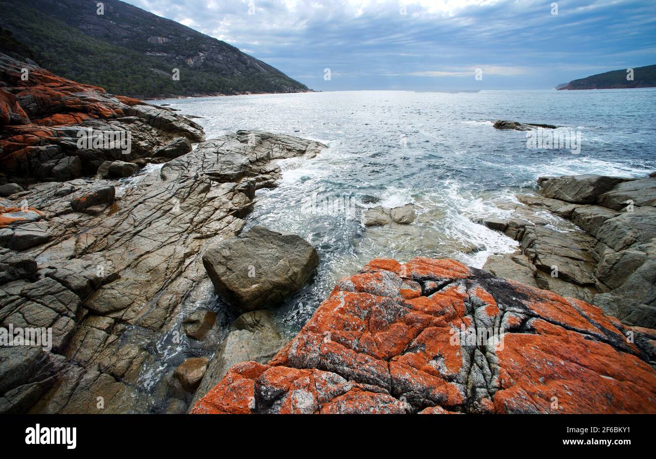 Red icean shoreline Stock Photo - Alamy