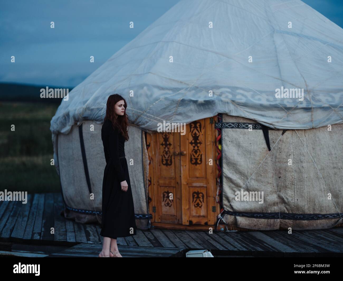 A woman in a dress near the traditional Mongolian dwelling yurt Stock ...