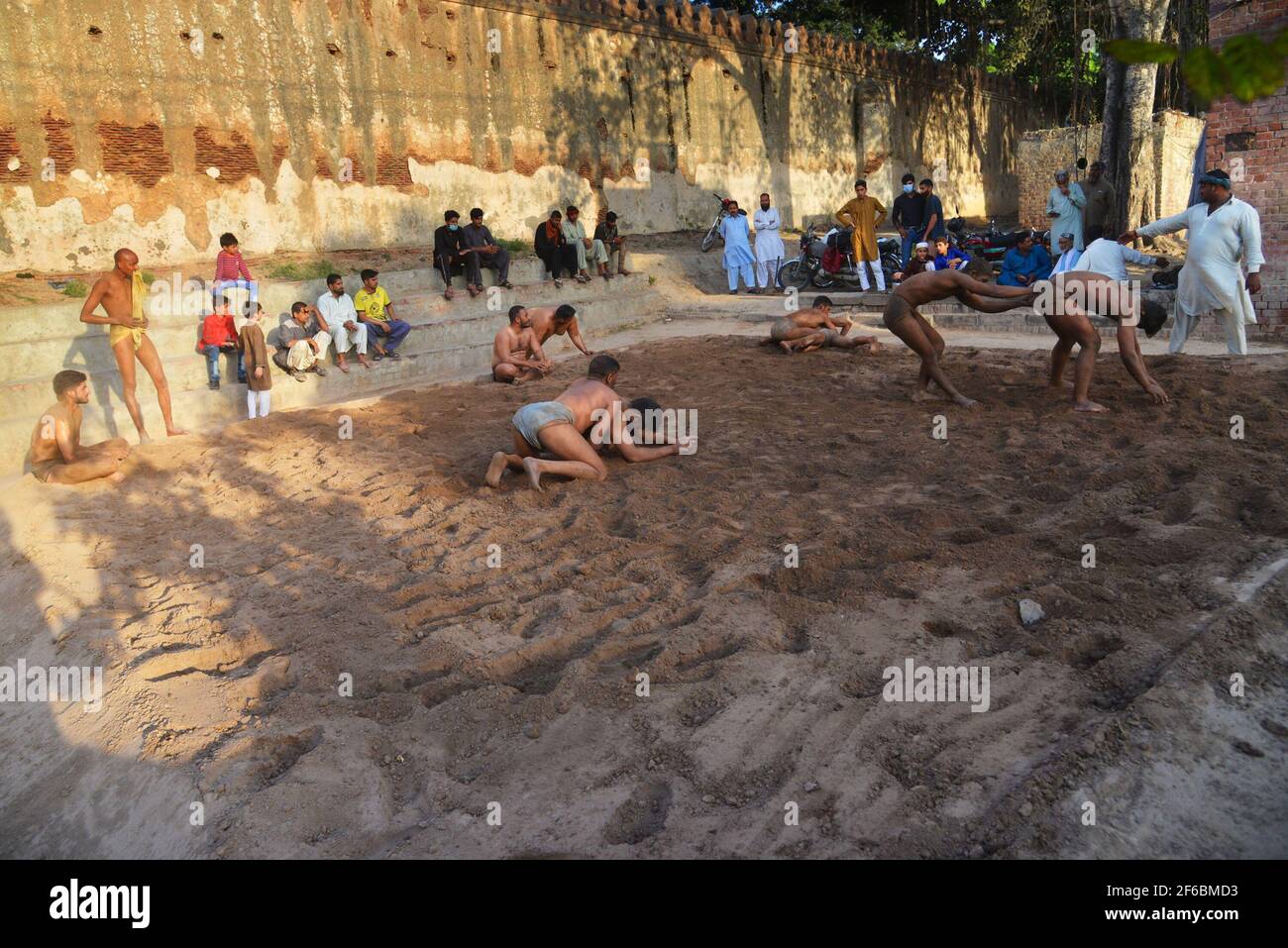 Pakistani Traditional wrestlers or Pehalwans are busy practicing at an ...