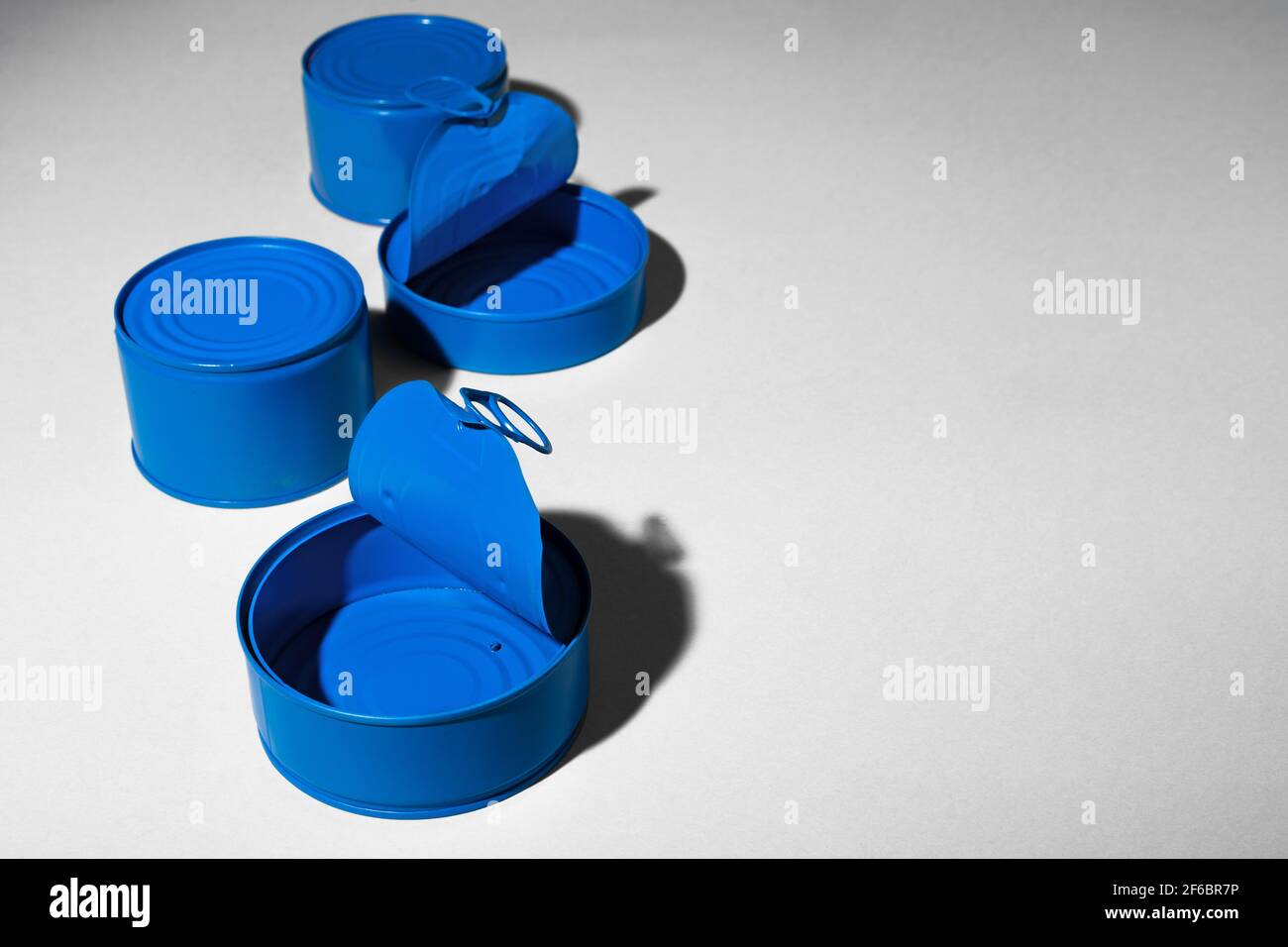 Blue tin can on gray background with shadow Stock Photo - Alamy