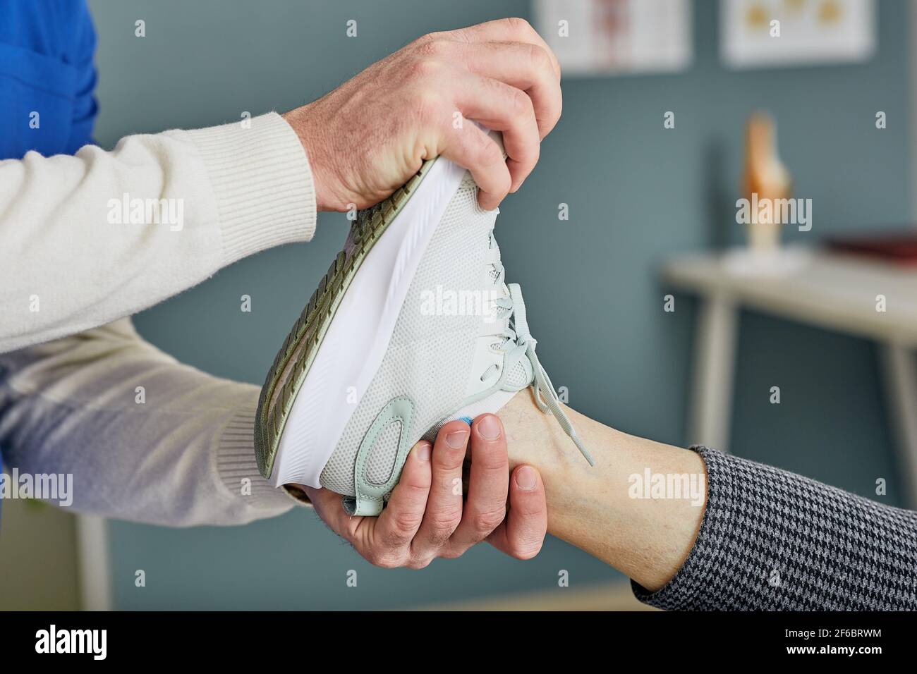 Orthopedist checks senior patient foot in a rehab center. Foot injury ...
