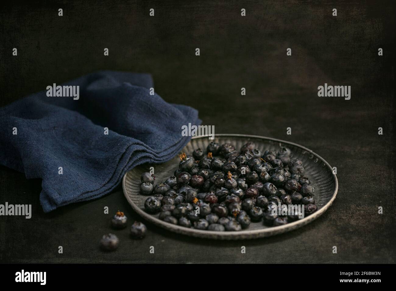 Raw blueberries in a tray on a dark background Stock Photo - Alamy