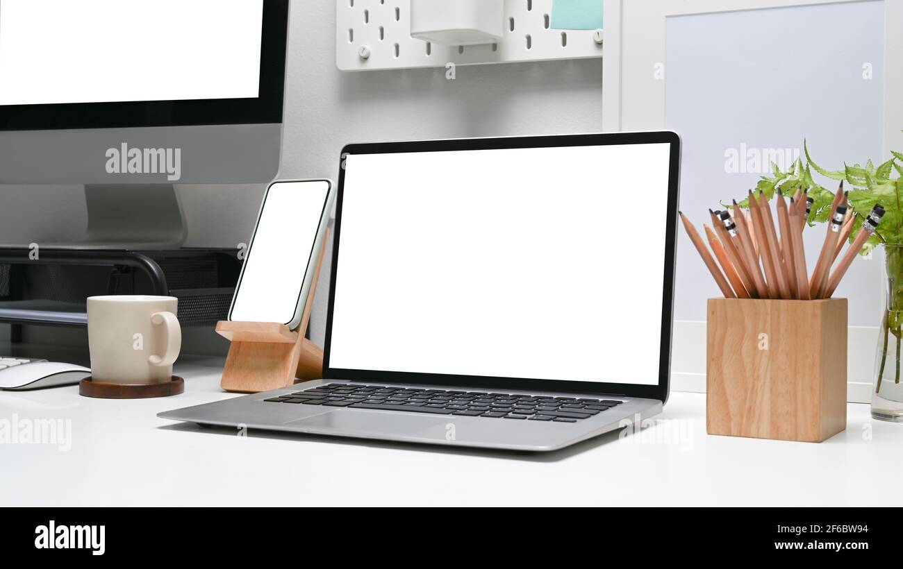 Designer workplace with computer laptop and smart phone with blank ...