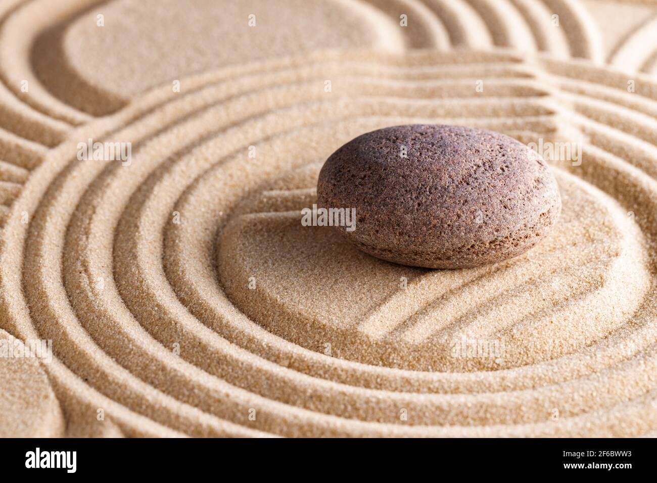 Japanese zen garden with stone in raked sand Stock Photo - Alamy