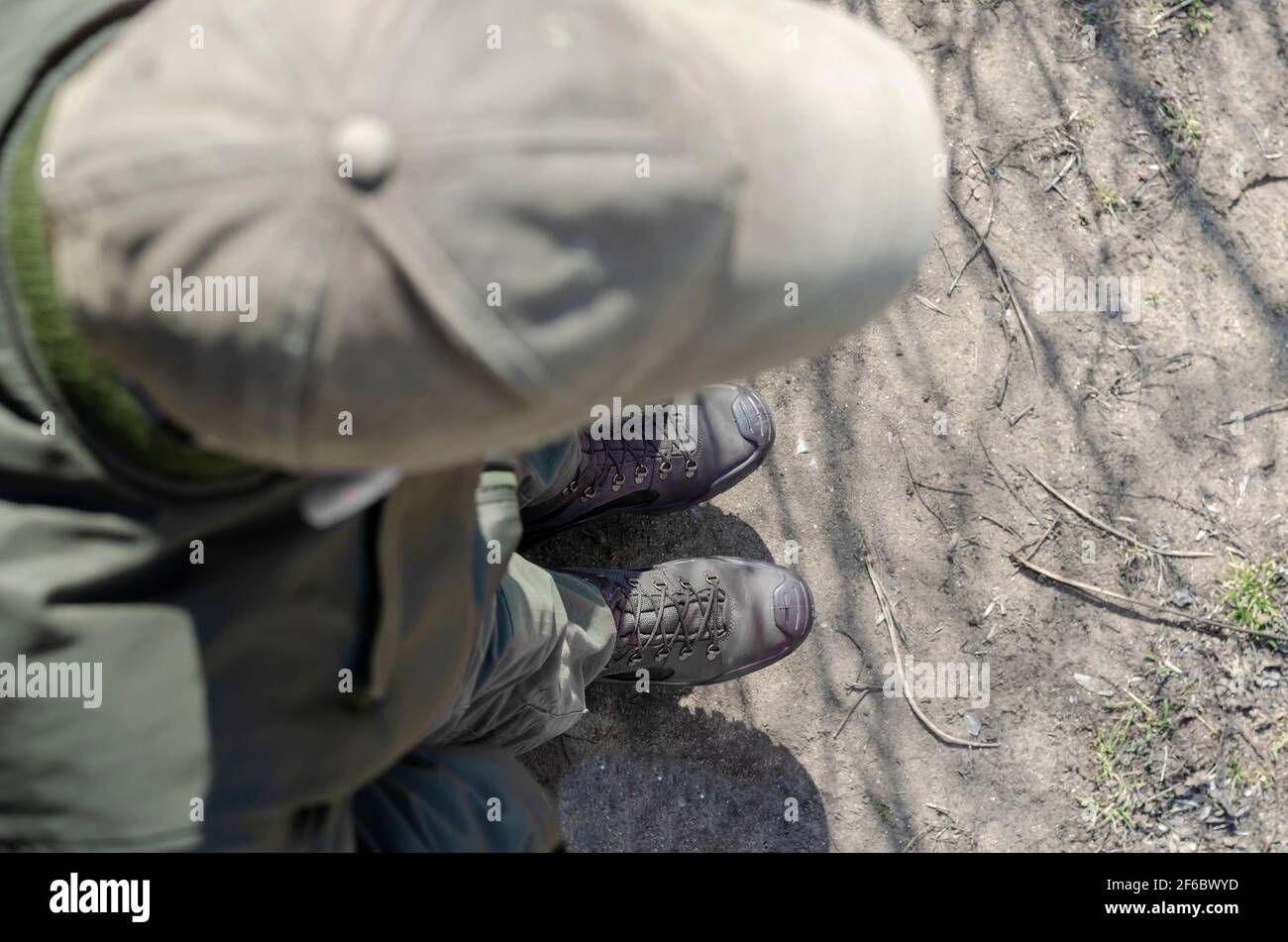 Overhead view of a man in military uniform. A soldier in a green cap ...
