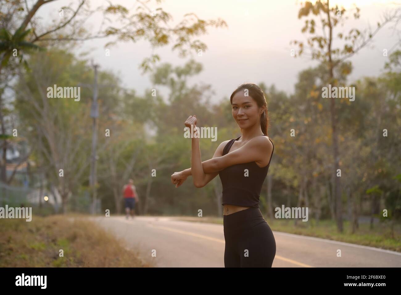 Young woman runner stretching arms before before outdoor workout Stock ...