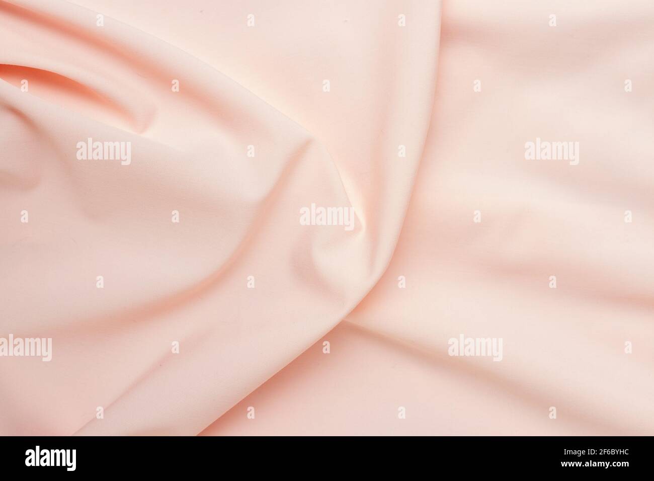 Silk pink fabric with a large fold and draped waves Stock Photo - Alamy