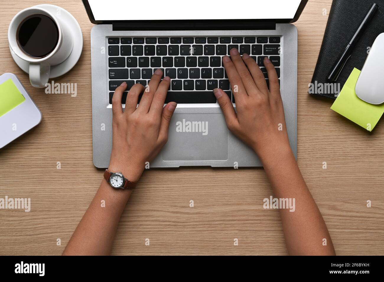 Overhead shot of female hands typing on laptop computer at office desk ...