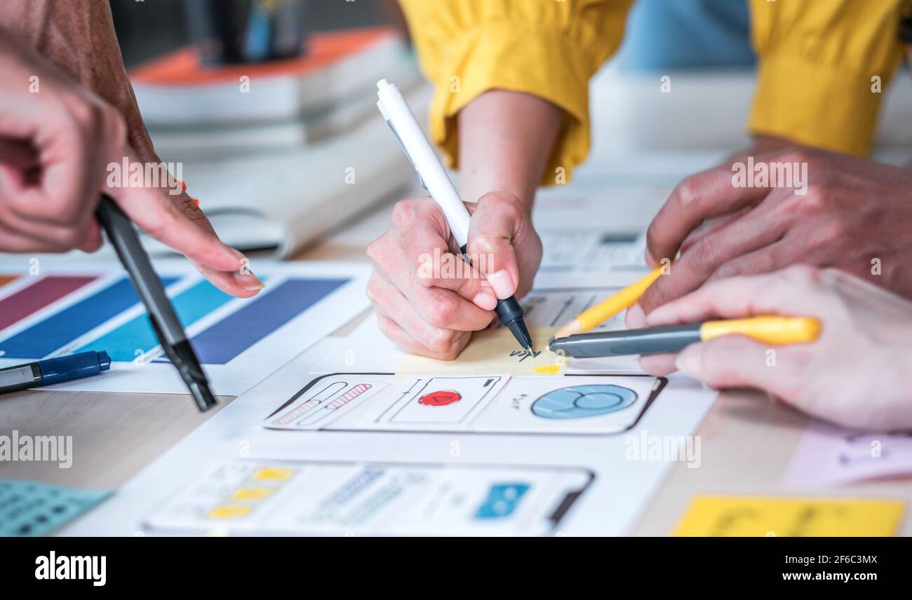 Close up hand ux developer and ui designer brainstorming about mobile ...