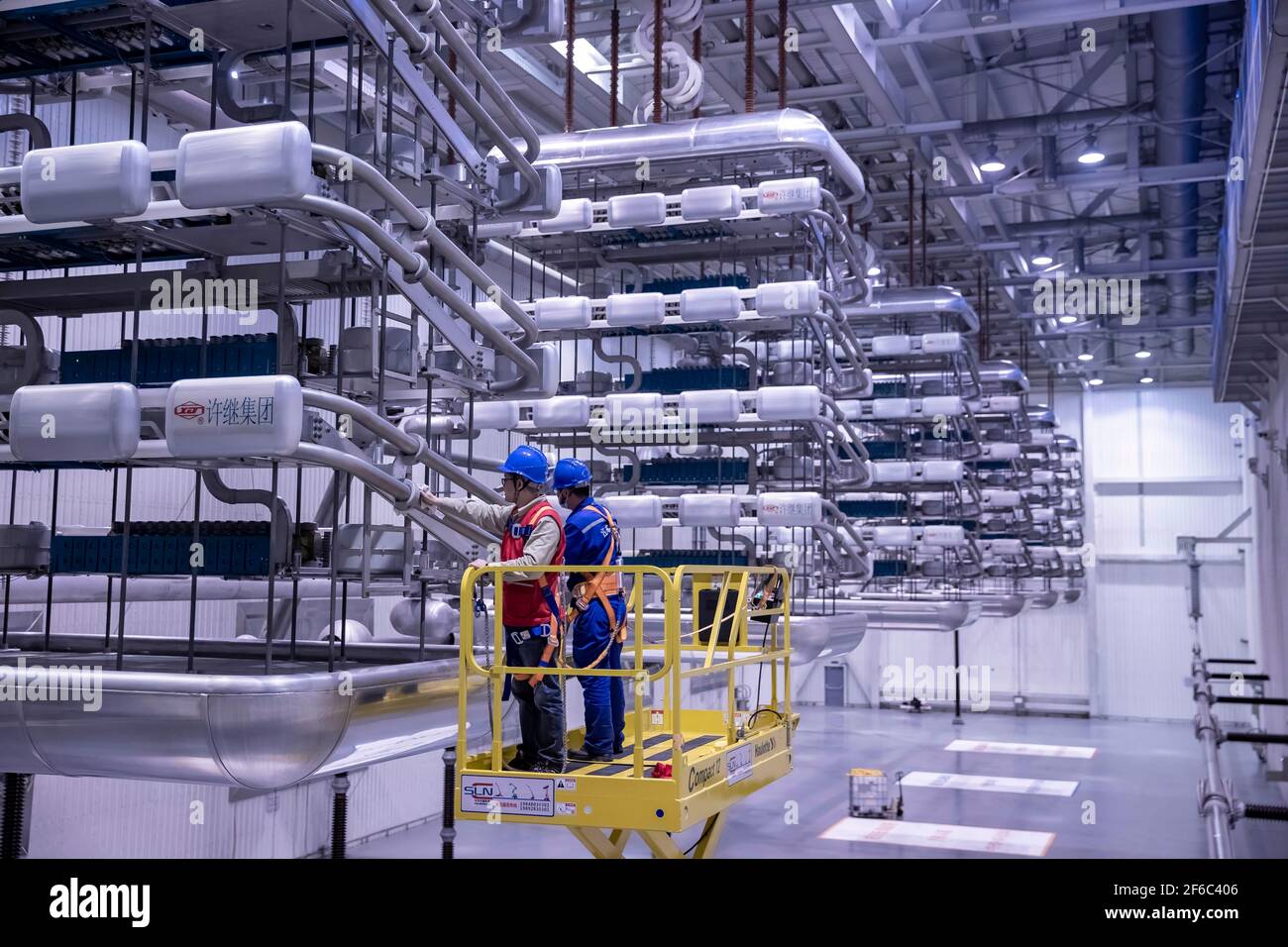 SUZHOU, CHINA - MARCH 31, 2021 - An electric worker rides a lift car to ...
