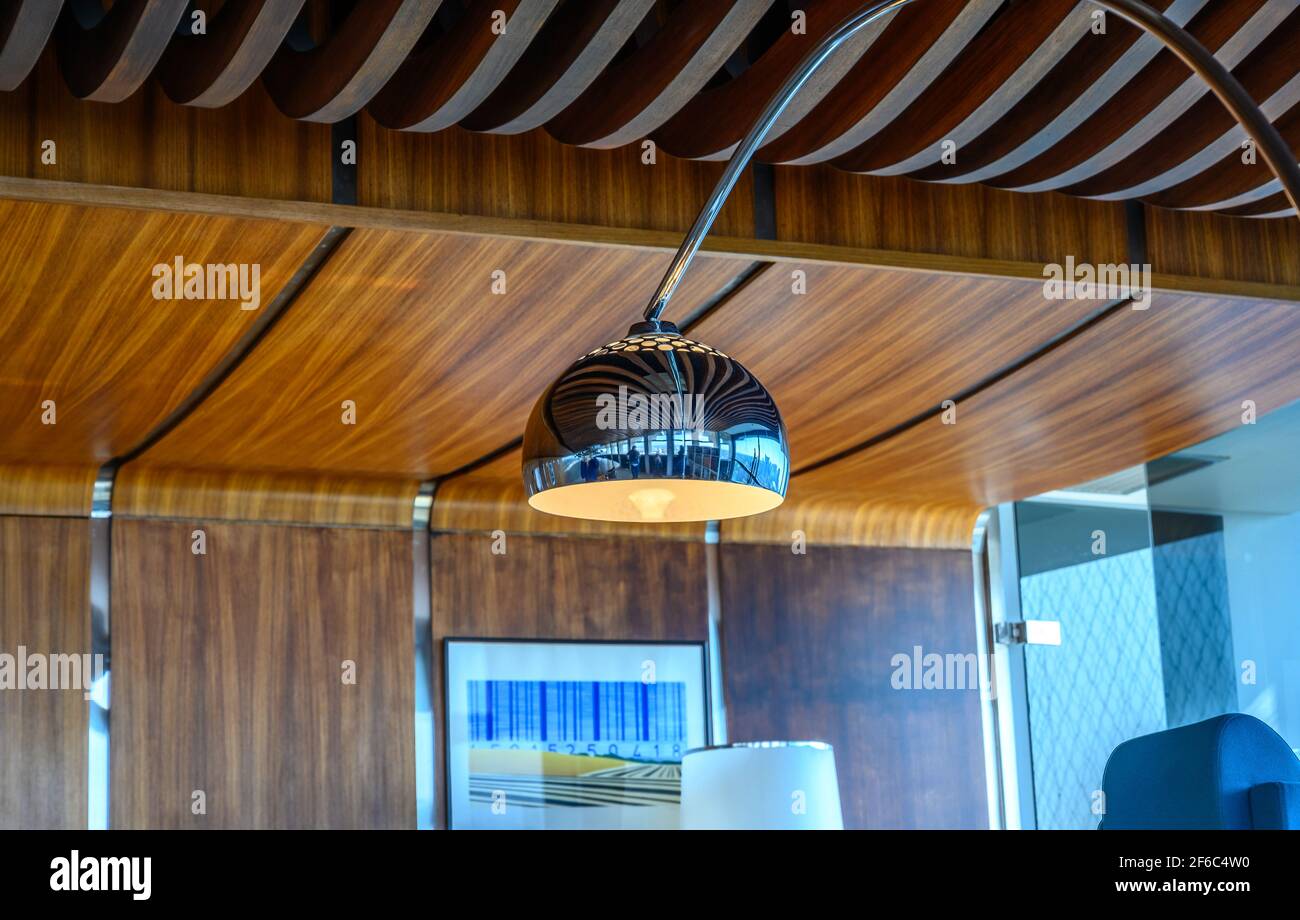 Close-up of stainless steel rounded lamp shade and wooden decorated ...