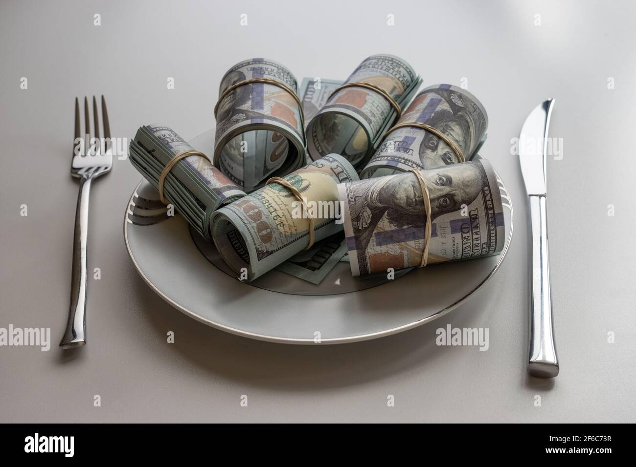Cash in plate hundred dollar bills on white background, Money meal ...