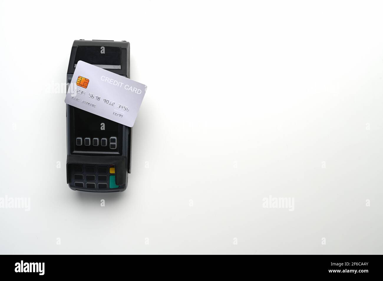 Payment terminal and credit card isolated on white background. Copy ...