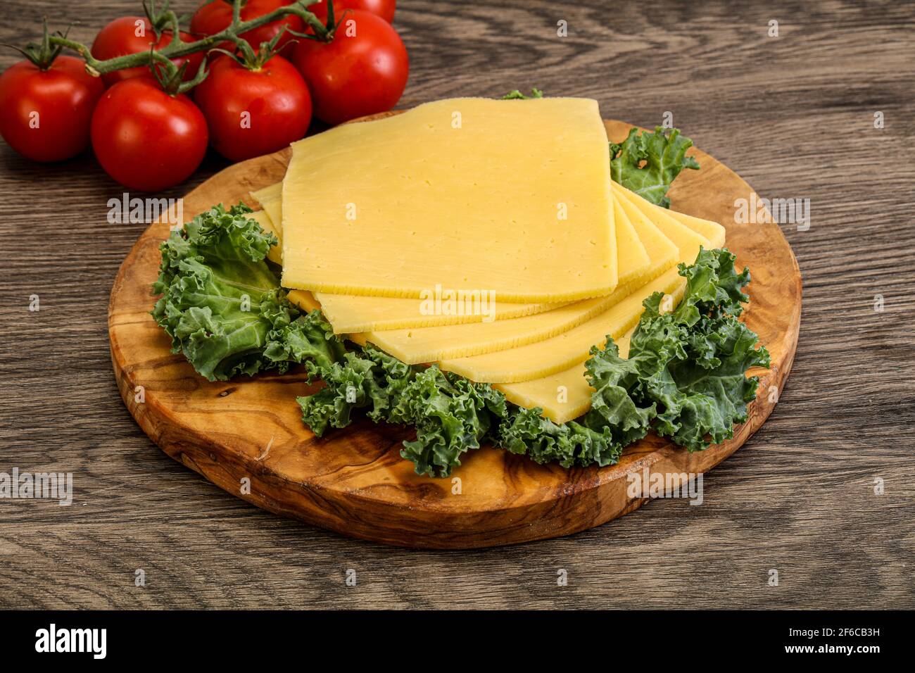 Sliced Gauda cheese snack over board Stock Photo - Alamy