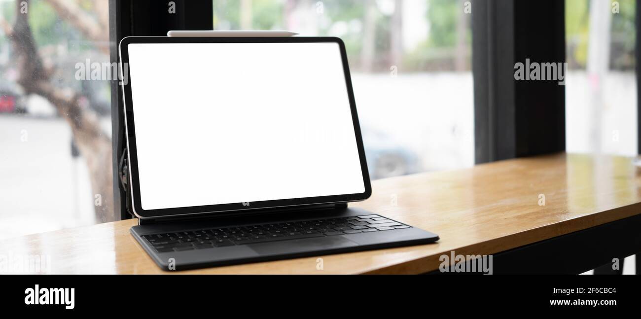 Close up view of computer tablet with blank screen on wooden table near ...
