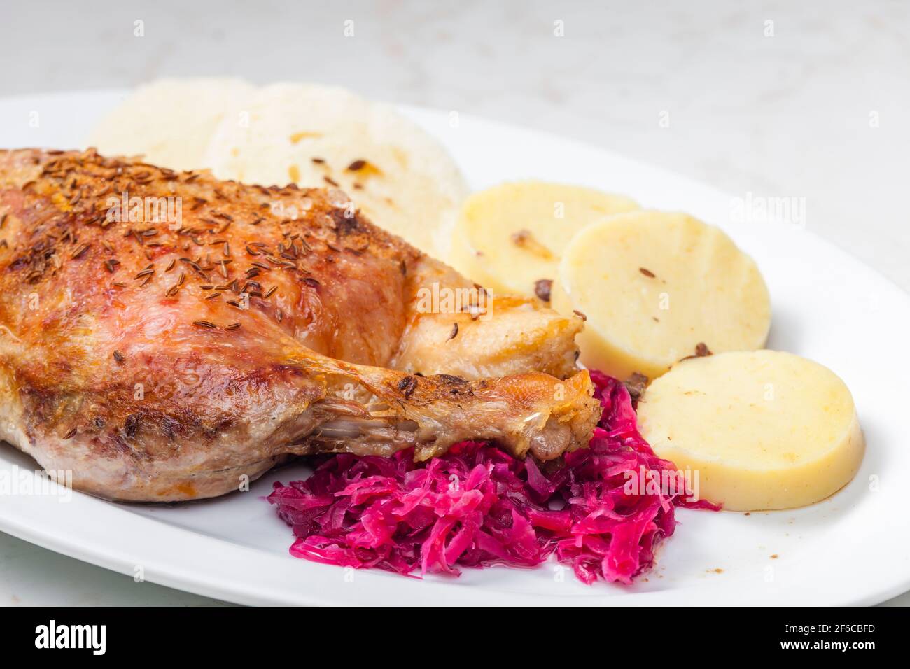 roasted goose leg with red cabbage and dumplings Stock Photo - Alamy