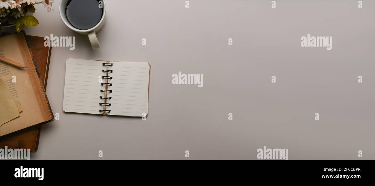 Horizontal image of workplace with coffee cup, empty notebook and copy ...